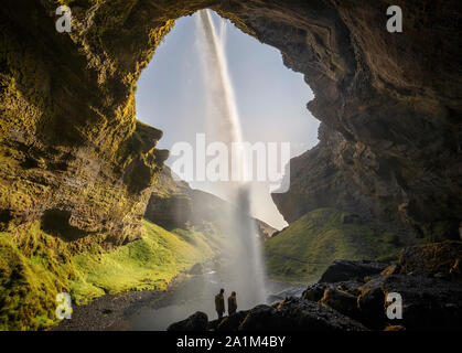 Behind a waterfall from inside a cave at Port Mora on the coastal path ...