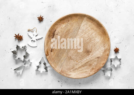 Flat lay with Xmas decorations in green and red with frosted berries ...