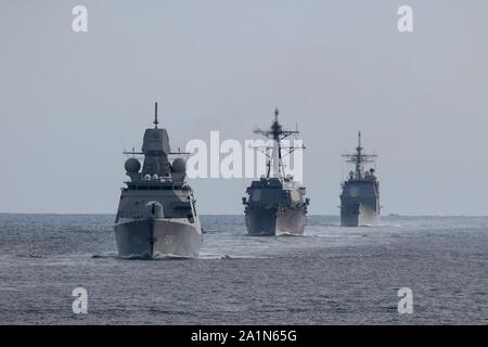 The Dutch frigate HNLMS De Ruyter with the amphipious assault ships ...