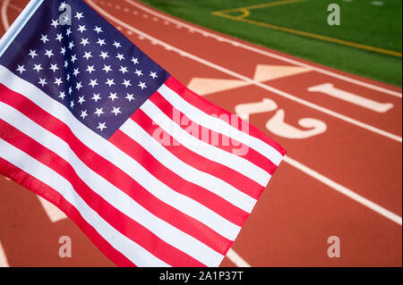 American flag flying over the numbered lanes of the start line of an ...