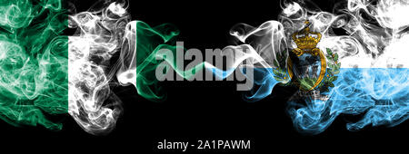 Nigeria and San Marino flag waving in the wind against white cloudy ...