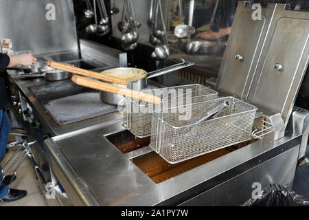 Deep fryers with boiling oil on fast food kitchen Stock Photo - Alamy