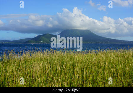 Day view of the Nevis Peak volcano across the water from St Kitts Stock ...