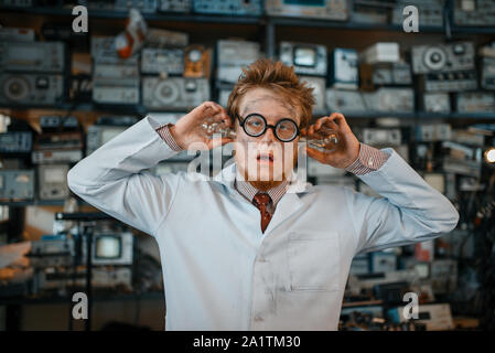 Engineer with electric lamps in ears, test in lab Stock Photo - Alamy