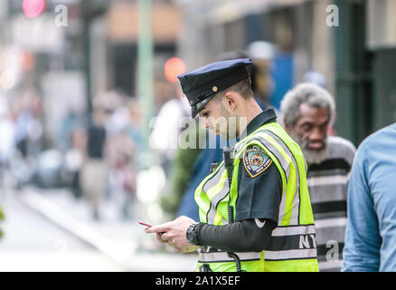 New York City, 9/27/2019: NYPD officer wearing a reflective vest over ...