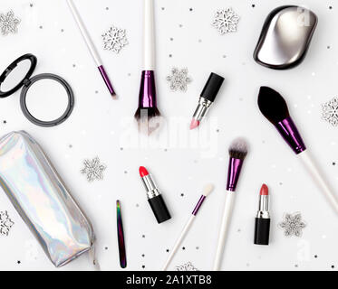 Makeup products and Christmas decorations on color background. Top view ...
