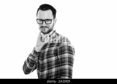 Studio shot of young man with pinky finger on mouth Stock Photo - Alamy