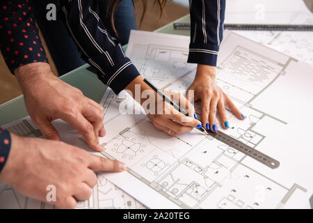 Architecture team drawing something while working with blueprint in the ...