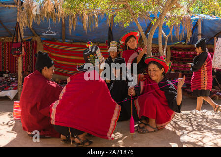 Women sitting, talking and knitting, indigenous village of Puka Puka ...