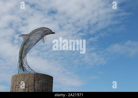 Metal dolphin statue, Portsoy harbour Stock Photo - Alamy