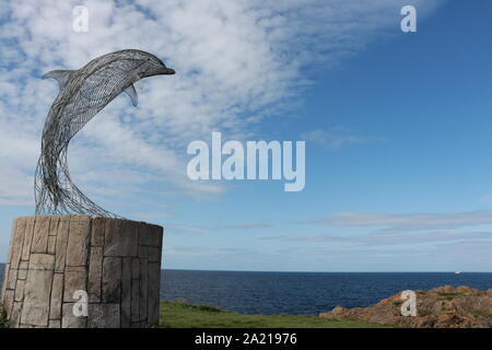 Metal dolphin statue, Portsoy harbour Stock Photo - Alamy