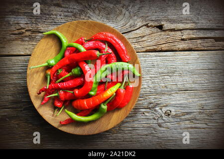 Wooden bowl with red, chilli pepers on rustic dark background Stock ...