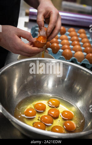Food preparation - eggs and yokes in stainless steel mixing bowl Stock ...