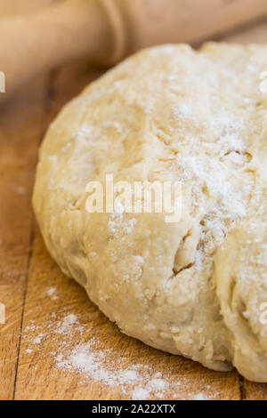Ball of raw dough, wheat and rolling pin on wooden background Stock ...