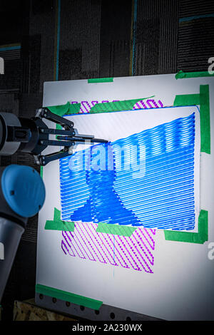 Robotic arm creating a portrait on paper from a digital file Stock ...