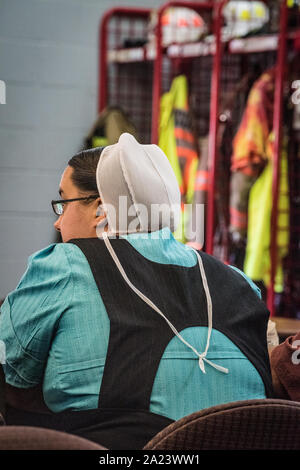 Amish family at country fair, auction Stock Photo - Alamy