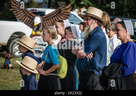 Amish family at country fair, auction Stock Photo - Alamy
