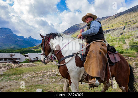 Montana, AUG 25: Cowboy riding on a horse in the Many Glacier area of ...