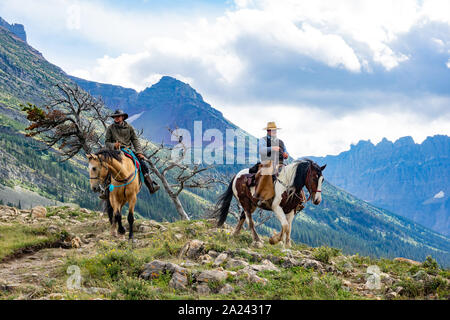 Montana, AUG 25: Cowboy riding on a horse in the Many Glacier area of ...