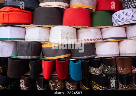A large selection of Muslim hats, Kufi, Taqiyah, Topi, in a religious ...