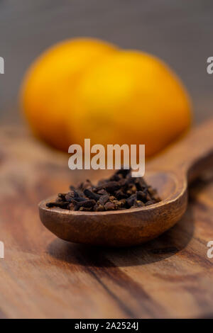cloves spices in spoon on white background Stock Photo - Alamy