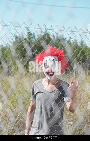 Scary horror clown looking through window Stock Photo - Alamy