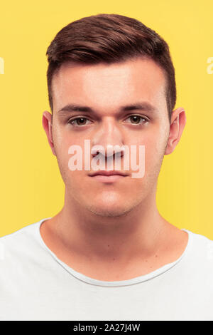 So serious. Mans portrait yellow background. Portrait of guy with ...