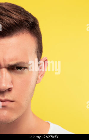 So serious. Mans portrait yellow background. Portrait of guy with ...