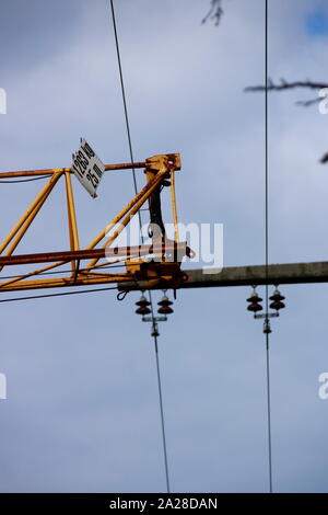 Crane moves at safety distance under a power line Stock Photo - Alamy