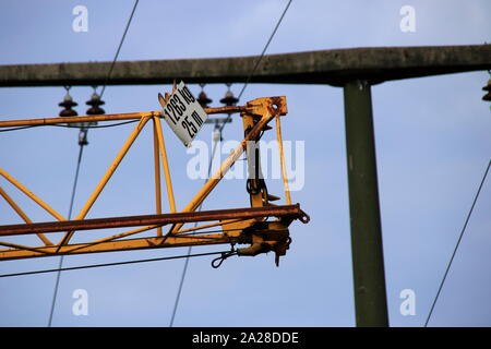 Crane moves at safety distance under a power line Stock Photo - Alamy