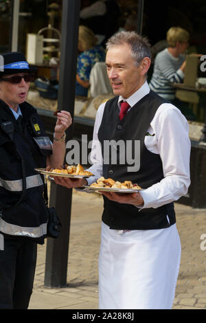 Staff handing out free samples at the cheese counter Stock Photo - Alamy