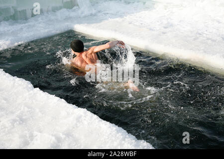 Man swimming in the ice hole, Odessa, Ukraine, Eastern Europe, Europe ...