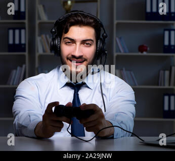 The businessman gamer staying late to play games Stock Photo - Alamy
