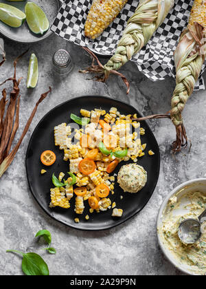 Shaved mexican street corn with herbed butter scoop on the plate Stock ...