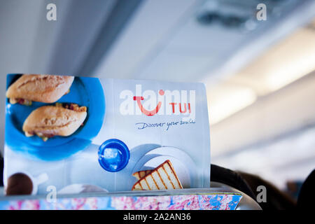 In-flight menu showing TUI brand on board a flight. Close-up of the ...