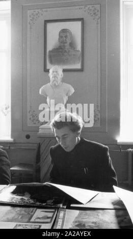 A student priest in the Zagorsk Monastery while studying. On the wall ...