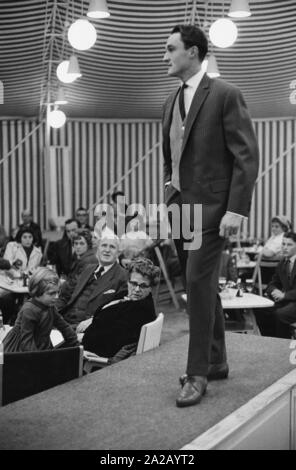 A male model presents a pinstripe suit with vest by couturier Heinz ...
