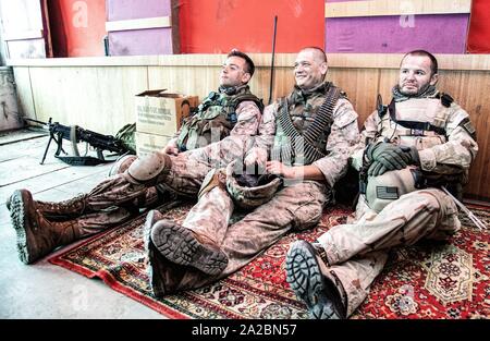 U.S. Marines talking and resting while sitting on the floor at their ...