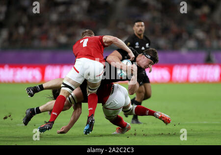 Scott Barrett of New Zealand is tackled by Dafydd Jenkins and Dewi Lake ...