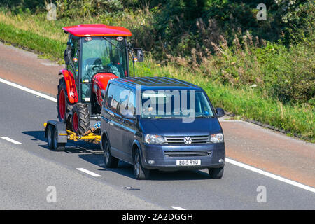 Van towing a trailer loaded with small tractor Stock Photo - Alamy