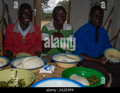 Malawian people eating Nshima / Nsima - a cornmeal porridge made in ...