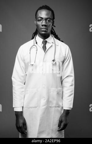 African american doctor man with dreadlocks wearing stethoscope holding ...