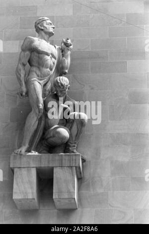 Sculpture in stone of two men fighting, behind is a summer sky Stock ...