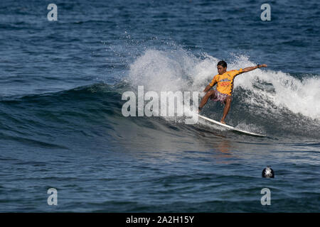 A surfer taking part in the Philippine National surfing Championships ...