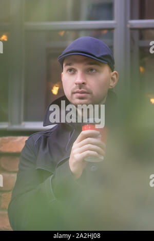 Autumn rainy weather and a young man with an umbrella Stock Photo - Alamy