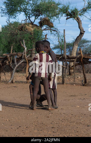 Turmi, Ethiopia - Nov 2018: Group of hamer tribe kids at the entrance ...