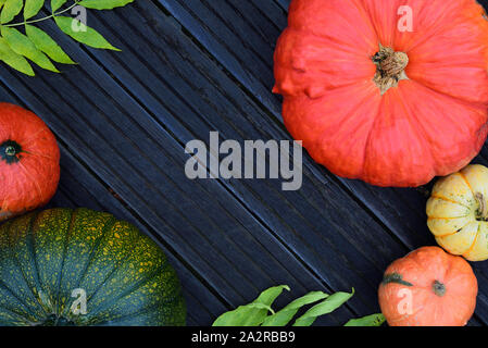 dark pumpkin in the form of happy monster in a hand on an ominous foggy ...
