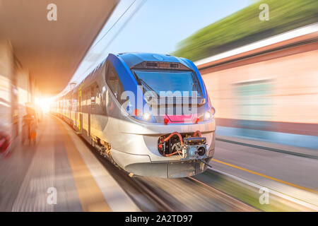 High speed train rides at high speed at the railway station in the city ...