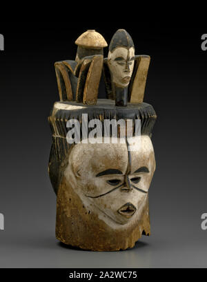 Janus-faced helmet mask with two human head finials, pigment, H: 19 in ...