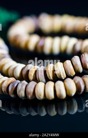 Islamic rosary beads of green color lie on the holy book of Muslims on ...